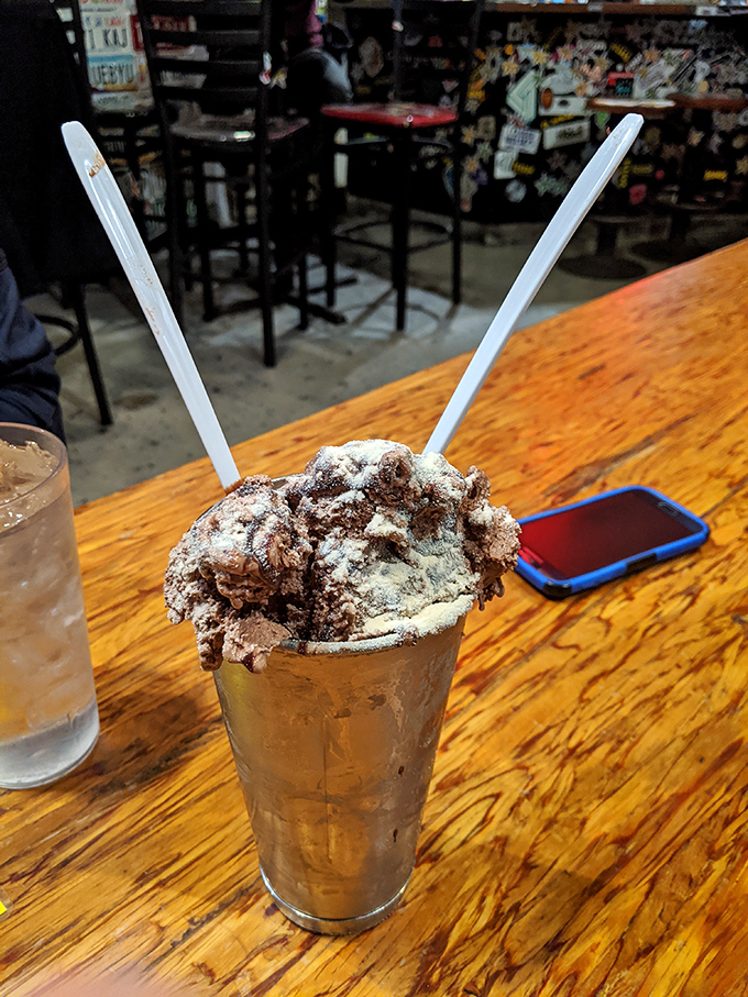 A chocolate malt so thick you need two straws—not to share, but to double your sipping power through this glorious dairy masterpiece.