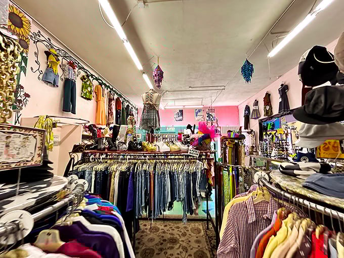 Clothing racks stretch toward the horizon, organized by color and type in this surprisingly orderly treasure cave.
