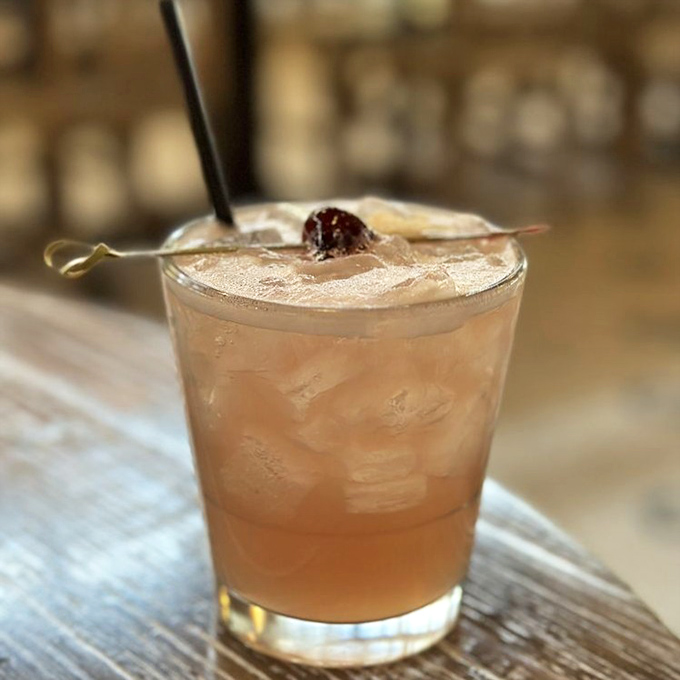 This cocktail isn't just a drink, it's a sunset in a glass, complete with that perfect cherry on top.