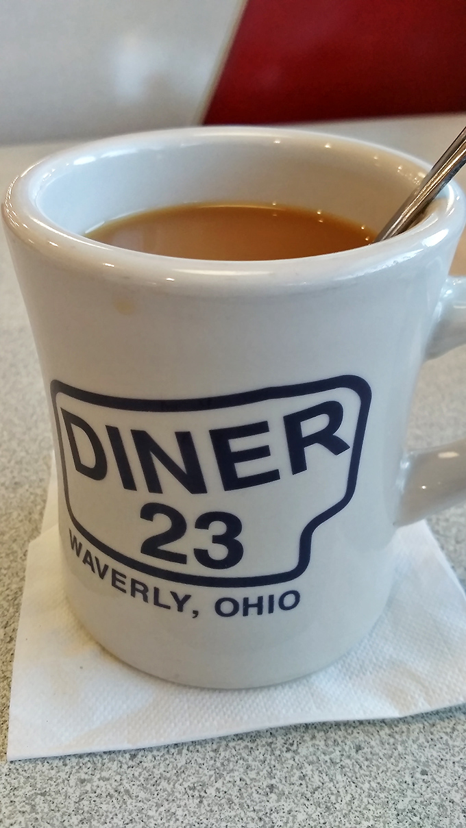 The official chalice of diner culture&mdash;a sturdy white mug emblazoned with pride of place. Coffee inside: hot, strong, and judgment-free.