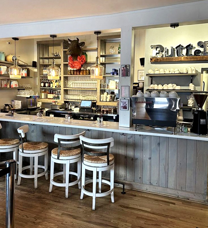Counter seating where breakfast dreams come true, complete with rustic wood paneling and a watchful bovine supervisor keeping things in order.