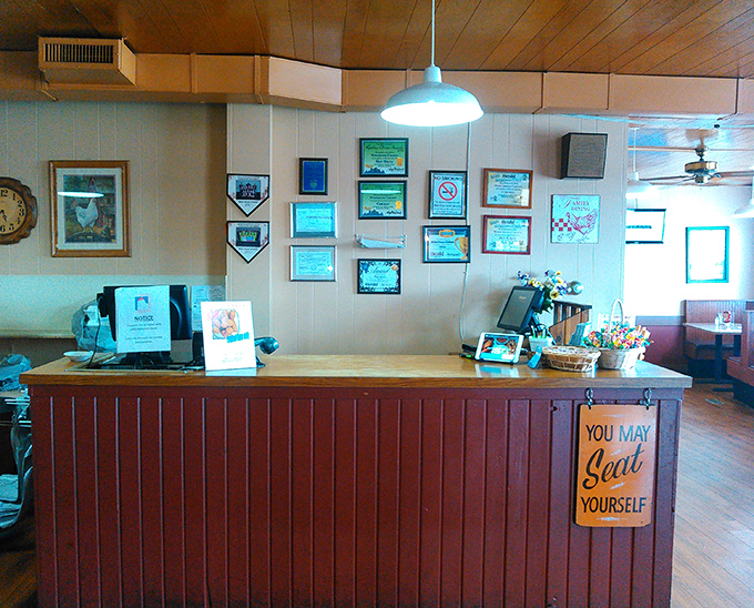 Decades of service recognized on these walls. The sign says "Seat Yourself," but locals know exactly where their favorite tables are.