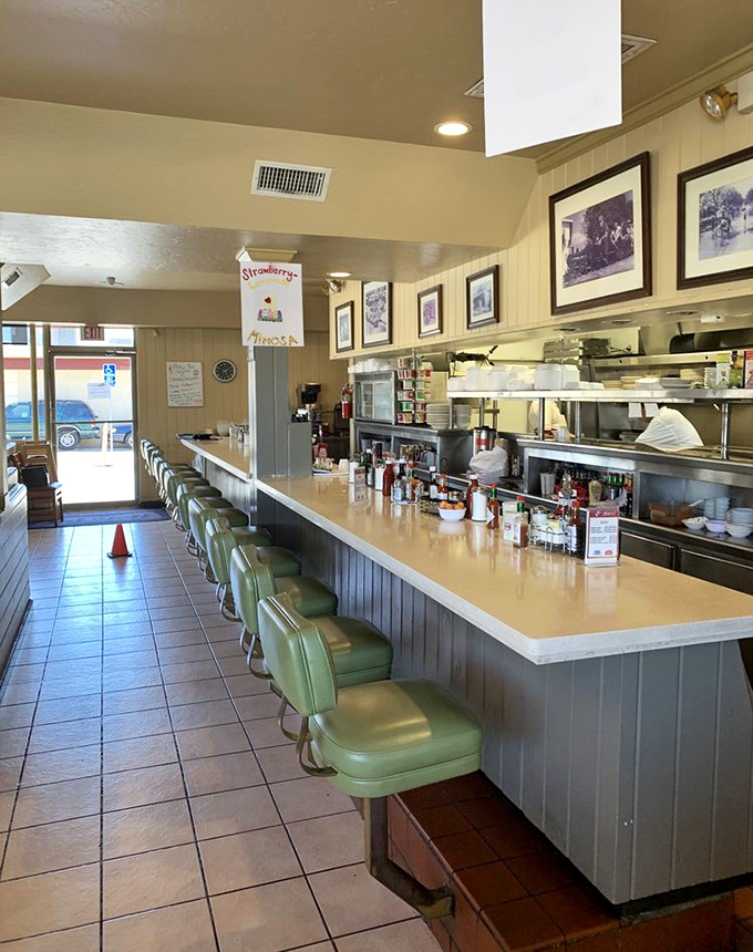 The counter where regulars become family and first-timers become regulars. Those mint green stools have heard it all.