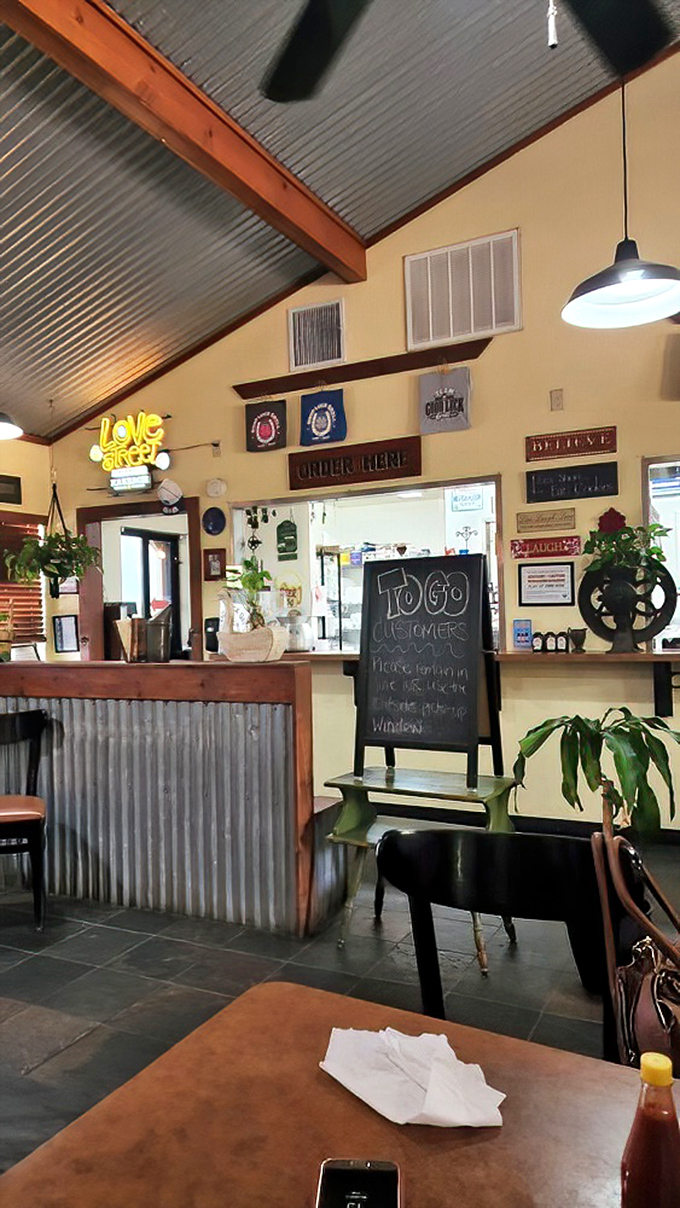 A neon "Love & Tacos" sign illuminates the ordering counter, where dreams of chicken fried steak and catfish begin their journey to reality.