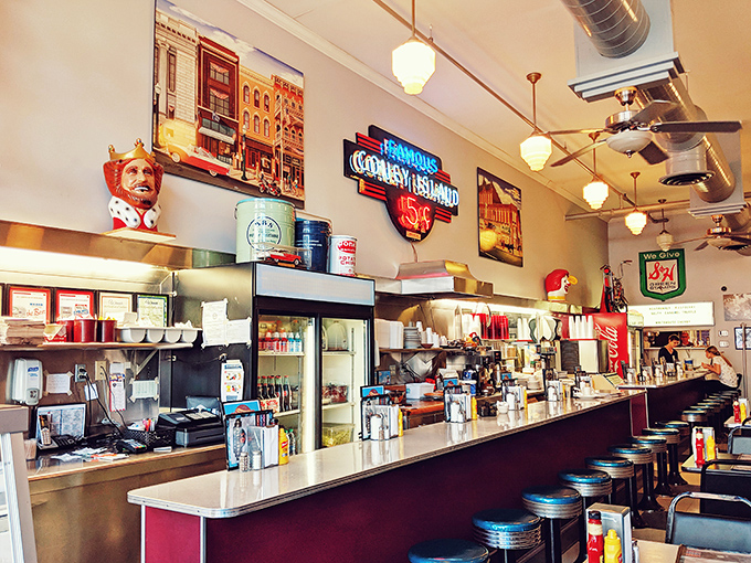 The counter view&mdash;where culinary magic happens. That neon sign glows like a promise that some things in this world remain deliciously constant.