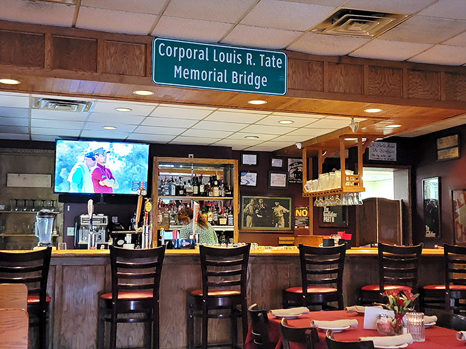 The bar area, where locals gather and first-timers become regulars, all under the watchful gaze of community history on the walls.