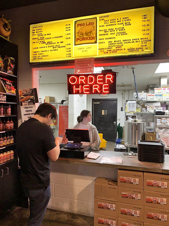 The "Order Here" sign glows like the pearly gates to barbecue heaven, where patient staff guide you through important life decisions.