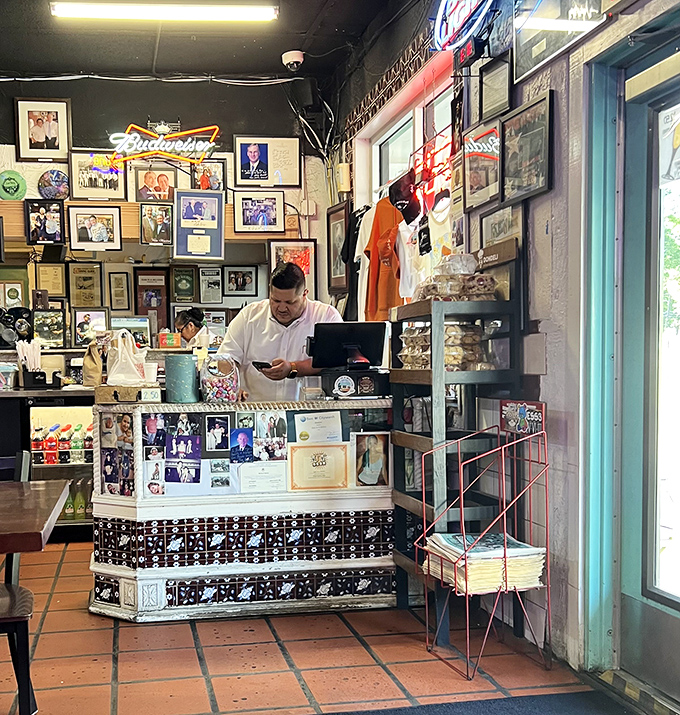 The counter tells stories of Austin's history through photos and memorabilia, while staff orchestrate the breakfast taco ballet behind it.