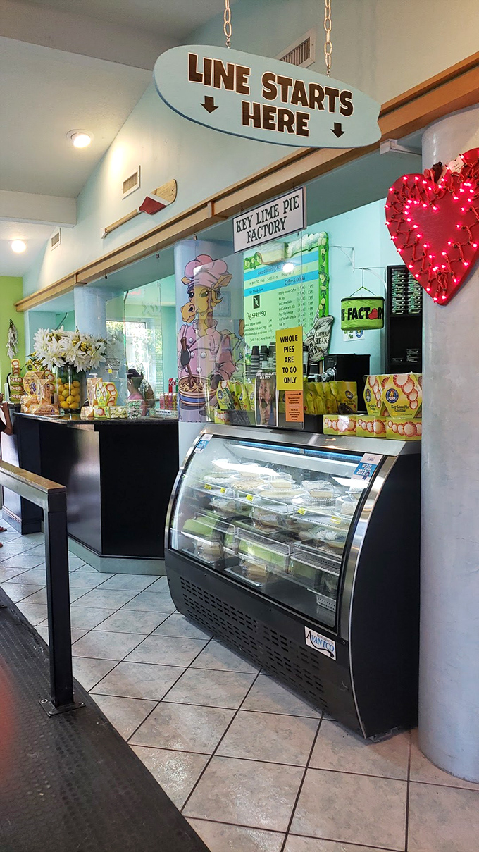 The counter where dreams come true, complete with a display case showcasing the day's freshly-made pies and a charming giraffe mascot.