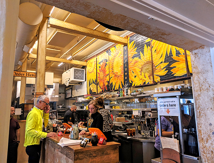 Where the magic happens. That sunflower mural isn't just decoration&mdash;it's a preview of the sunny flavors coming from behind the counter.