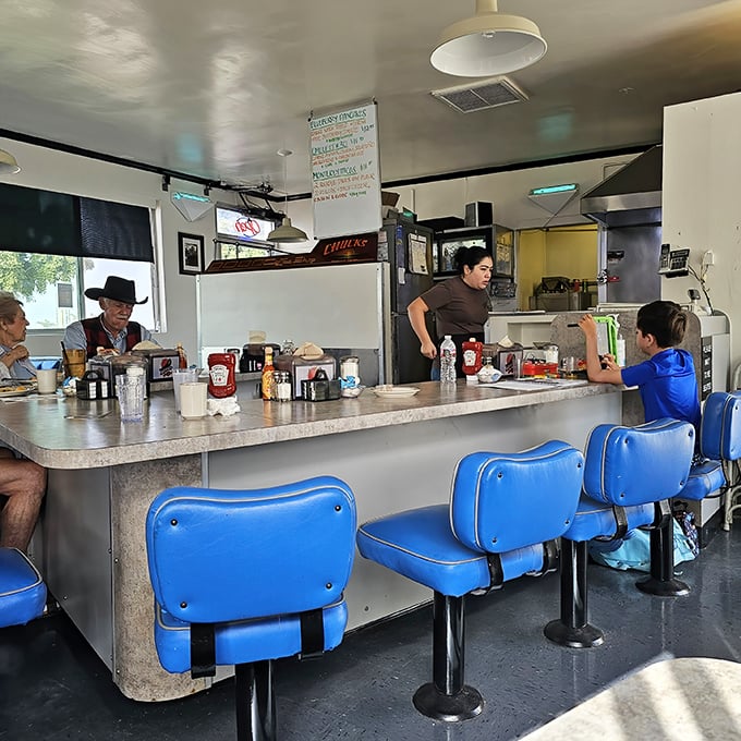 Blue seats at the counter offer front-row tickets to the best show in town: breakfast being made with decades of practice.