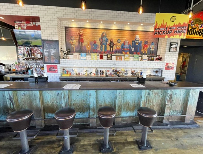 The bar's weathered blue patina and retro stools invite you to belly up for burgers and brews – like a hipster diner designed by someone who actually likes food.