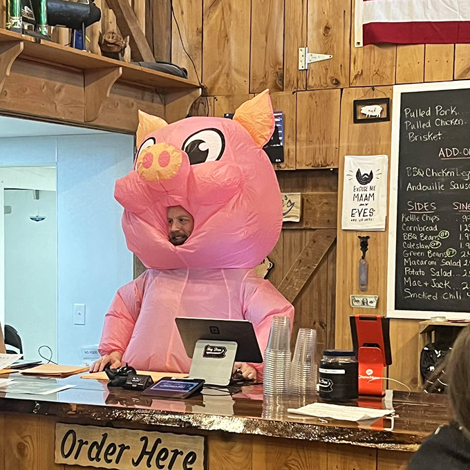 When your cashier dresses as a pig, you know they have both humor and honesty about their business model. Points for thematic commitment.