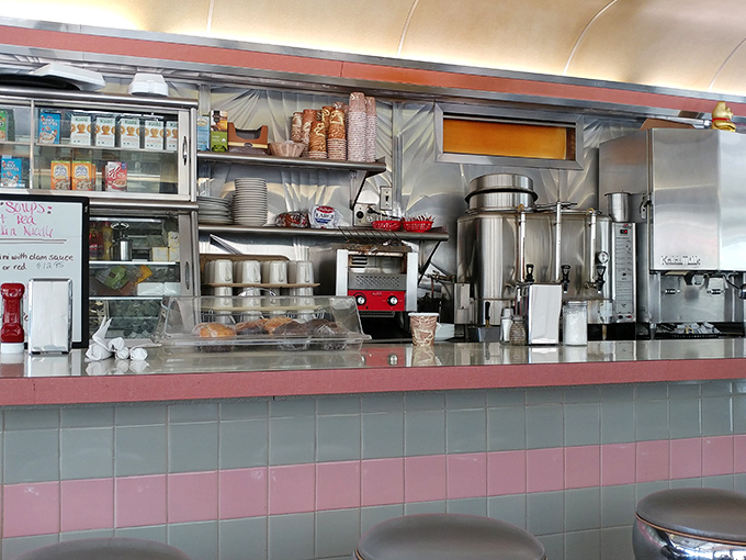 Behind this counter, short-order wizards transform simple ingredients into comfort food masterpieces while keeping the coffee flowing like a lifeline.