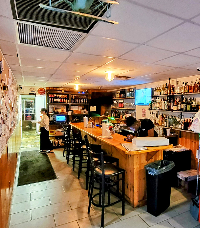 The bar area offers liquid refreshment for those moments when a burger requires proper hydration accompaniment.