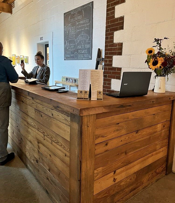 The reception desk welcomes you with rustic charm and sunflowers. First impressions matter, and this one says "you're about to have a wonderful time."