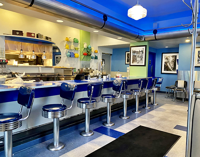 Blue counter stools lined up like loyal soldiers, ready to support you through pancakes, burgers, and life's big decisions. Classic Americana at its finest.