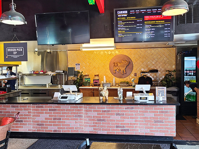 Behind this counter, pork magic happens daily. The open kitchen layout lets you witness the transformation from raw ingredients to carnitas glory.