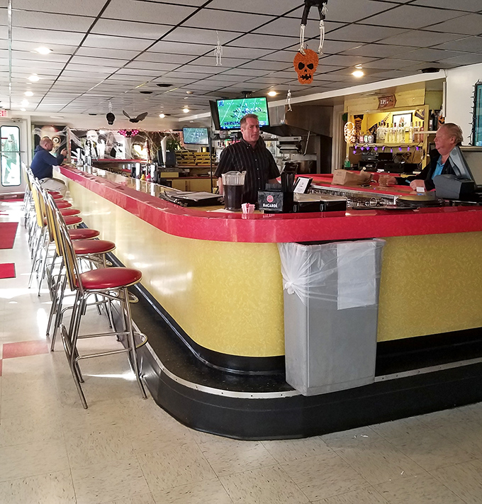 The yellow and red counter area channels pure Americana, where solo diners can enjoy both their meal and the floor show of diner operations.