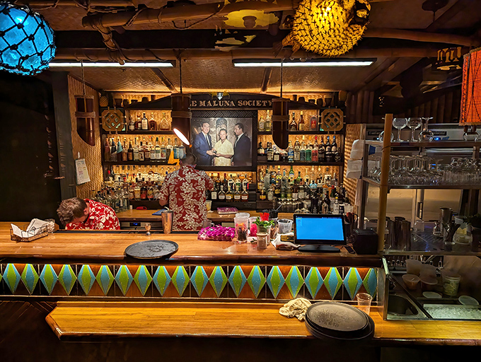 Behind every great tiki bar is a collection of bottles that promises adventure. This bartender is the captain of your flavor voyage.