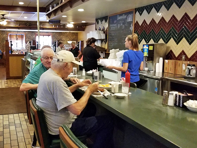 Counter dining &ndash; where regulars perch like oracles of breakfast wisdom, coffee mugs perpetually half-full, never half-empty.