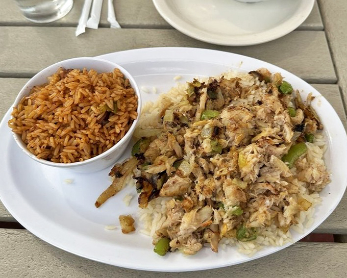 Red rice alongside a mountain of crab meat and vegetables&mdash;a plate that tells the story of Gullah-Geechee culinary influence in every grain.