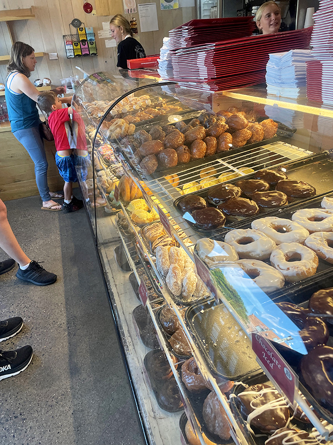 The display case: where willpower goes to die. Each shelf offers a different path to delicious surrender.