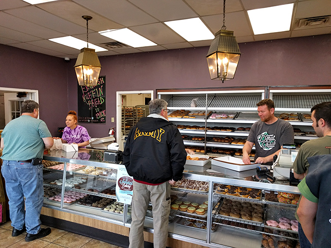 The morning ritual at Milton's: locals patiently waiting their turn while staff efficiently work their donut magic. Community in action.