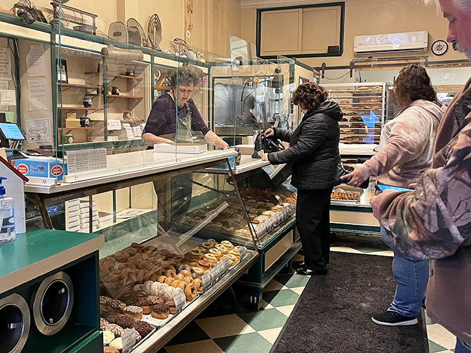 The morning ritual: customers patiently waiting their turn, knowing that some things—like perfect donuts—are absolutely worth the wait.