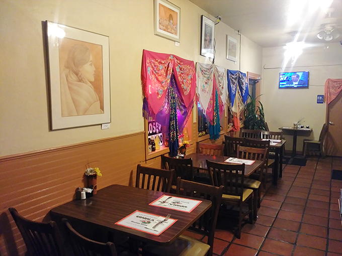 Colorful textiles and framed artwork transform a simple dining space into a cultural journey, where every meal feels like a celebration.