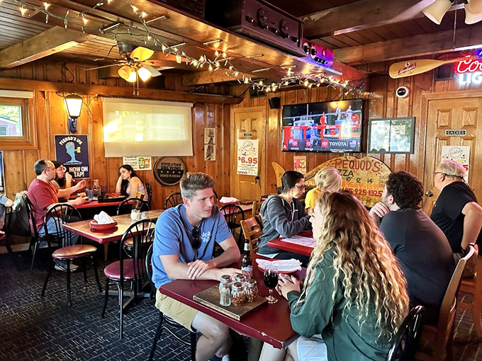 A dining room filled with people experiencing pizza euphoria. Notice nobody's looking at their phones &ndash; the pie demands full attention.
