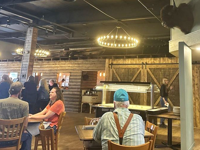 Circular chandeliers cast a warm glow over the dining room, where strangers become friends over shared appreciation of properly cooked meat.