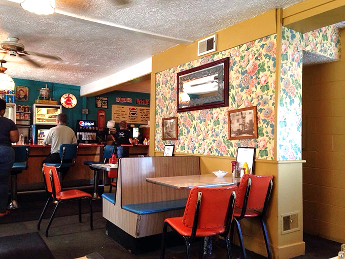 Floral wallpaper meets vinyl booths in a marriage of diner aesthetics that says, "We were cool before retro was cool."