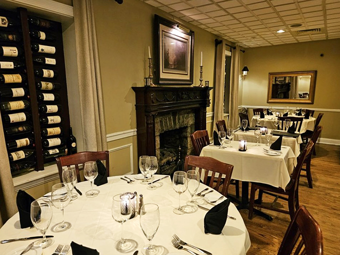 A dining room where the fireplace and wine rack compete for the title of "Most Likely to Make You Feel Fancy While Eating."