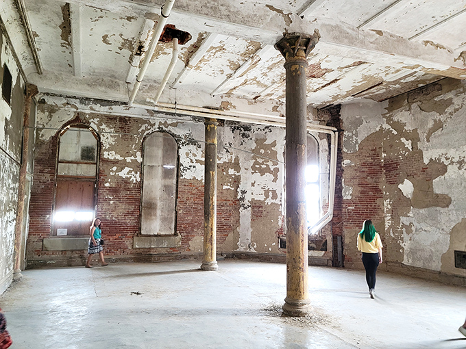 Decay becomes art in this abandoned room. The exposed brick and peeling paint create a canvas that urban photographers dream about. 