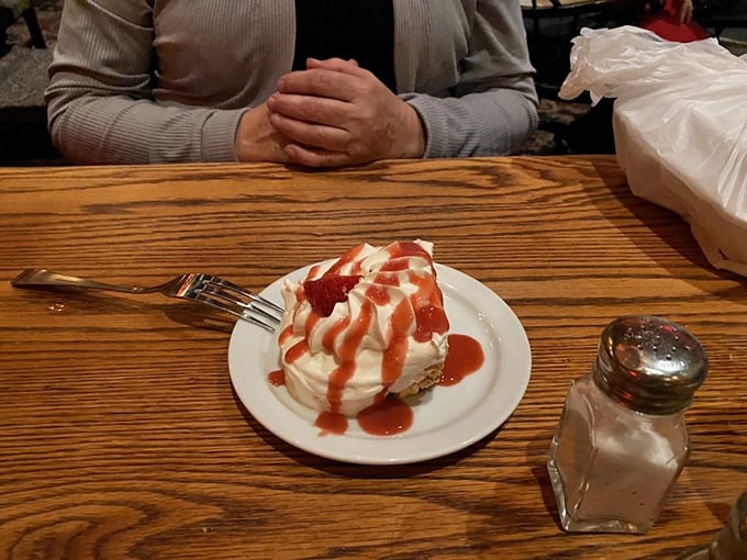 Dessert that doesn't need a filter&mdash;a cloud of whipped cream with strawberry sauce that looks like it's blushing from all the attention.