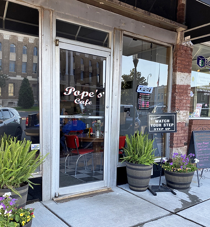 Planters flanking the entrance like sentries guarding the gateway to flavor town&mdash;a humble doorway that promises more satisfaction than many fancy establishments. 
