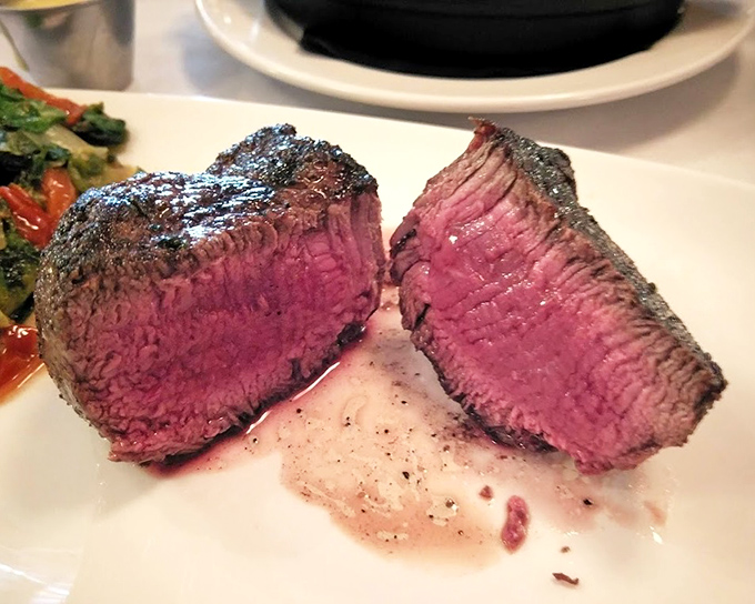 A perfectly cooked filet mignon that's pink in the middle like it's blushing from all the compliments it's about to receive.