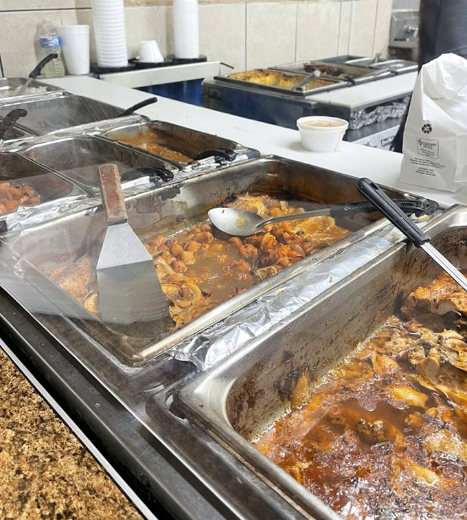 Behind these steam trays lie the secrets to happiness—each one a bubbling cauldron of Southern tradition simmered to perfection.