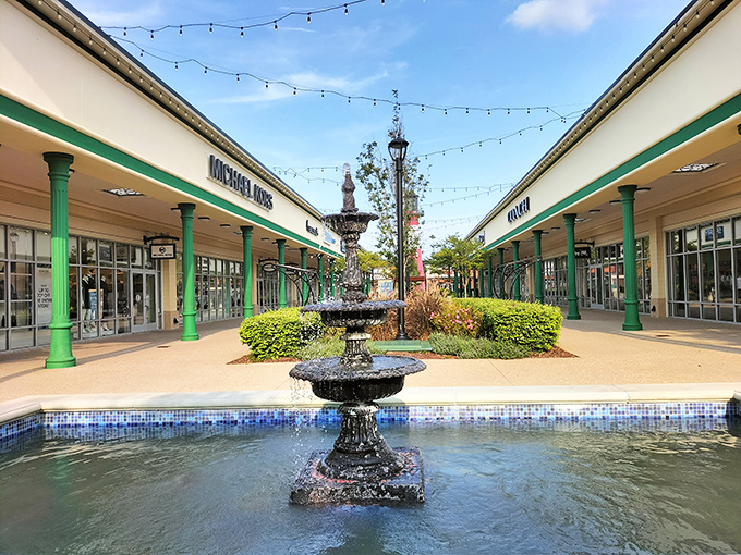 A classic fountain creates a moment of tranquility between Michael Kors and Coach, where shoppers can reflect on purchases made and purchases yet to come.
