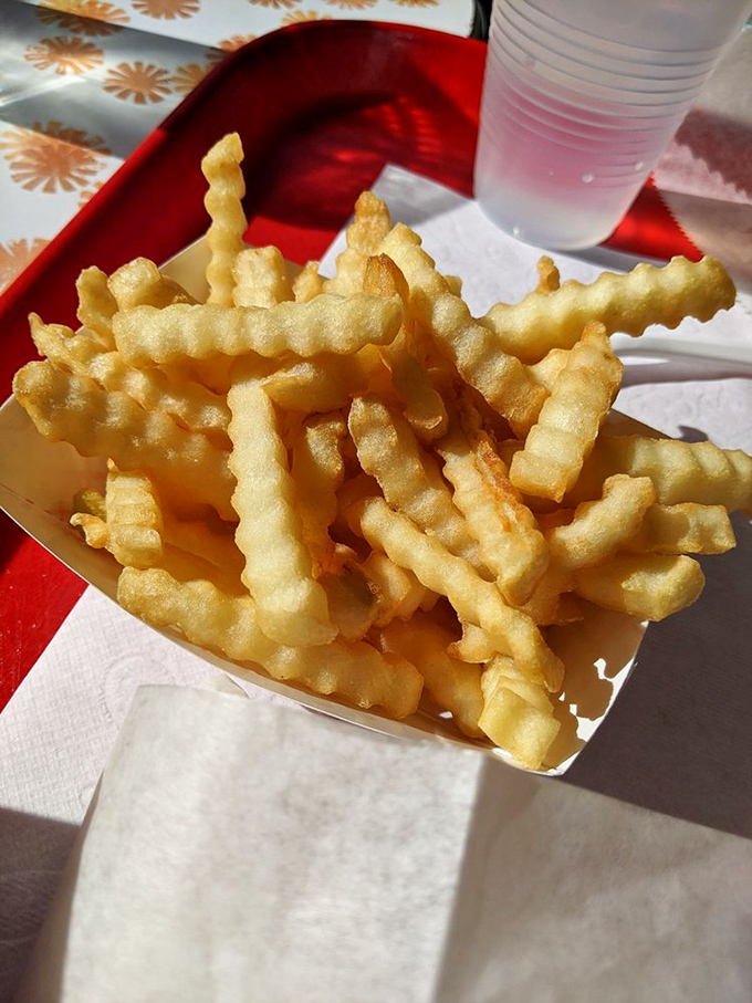 Crinkle-cut fries that achieve the golden trifecta: crispy exterior, fluffy interior, and just enough salt to make you reach for "just one more."