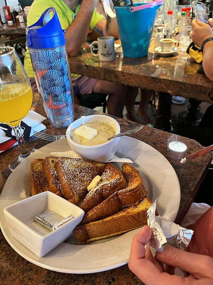 French toast transformed into an art form&mdash;thick-cut, golden brown, and served with a side of grits that would make any Southerner nod in approval.