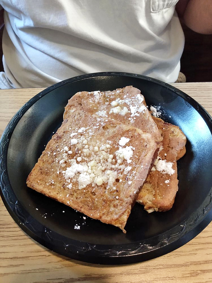 French toast that deserves its own morning anthem – golden, crisp-edged, and dusted with powdered sugar like the first perfect snowfall.