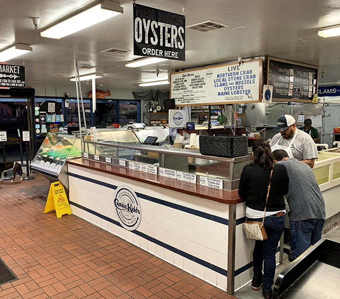 The seafood counter&mdash;where decisions are made, relationships tested, and the day's catch waits patiently for its moment of culinary glory.