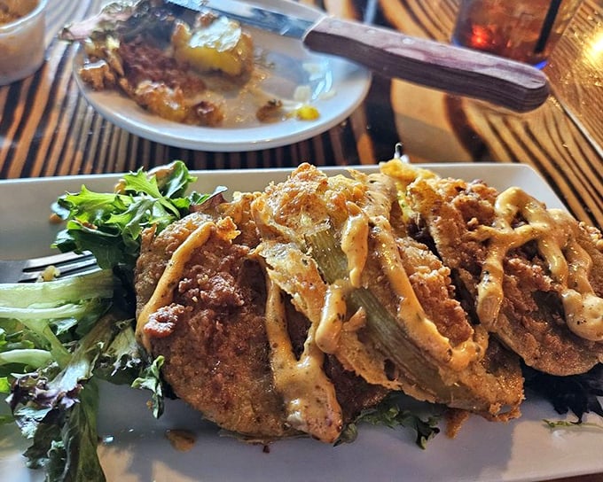 Fried green tomatoes &ndash; a Southern classic elevated. That drizzle of sauce adds the exclamation point to a delicious statement. 