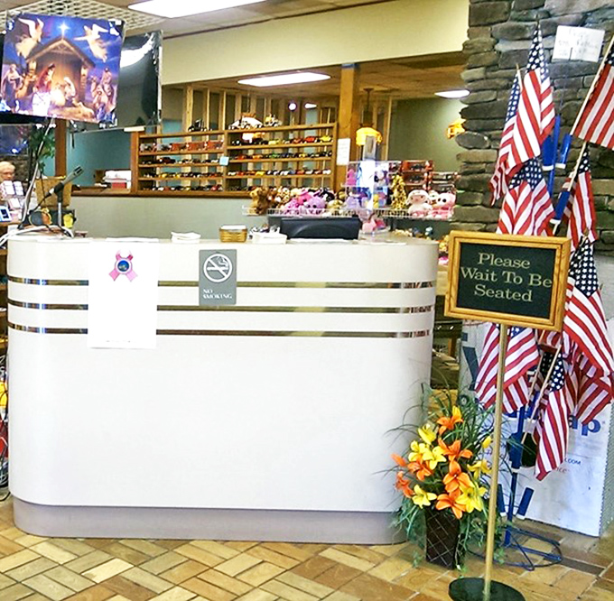 The front desk area, complete with American flags and a "Please Wait To Be Seated" sign&mdash;the gateway to comfort food paradise.