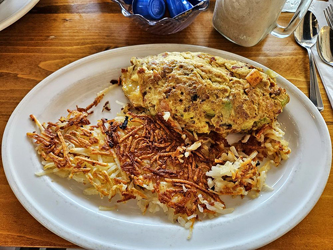 An omelet and hash browns that belong in the Breakfast Hall of Fame. The crispy-to-fluffy ratio is mathematical perfection.