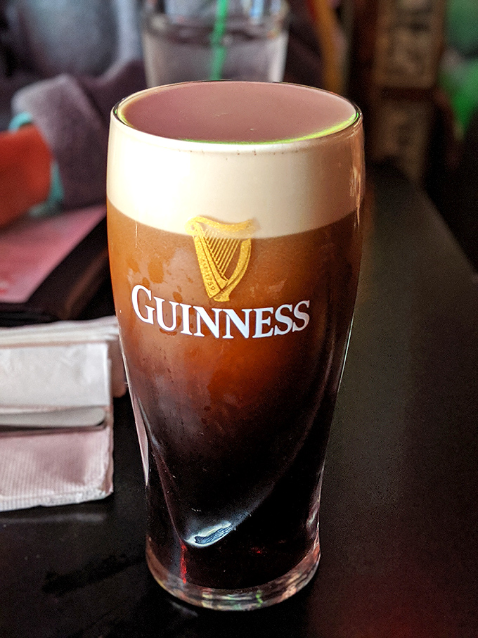 A properly poured Guinness with its perfect creamy head&mdash;proof that The Thurman Cafe respects tradition even while their burgers break all the rules. 