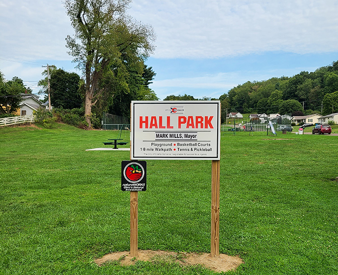 Hall Park's simple sign promises the timeless entertainment of open spaces, where kids can run wild without a single in-app purchase.