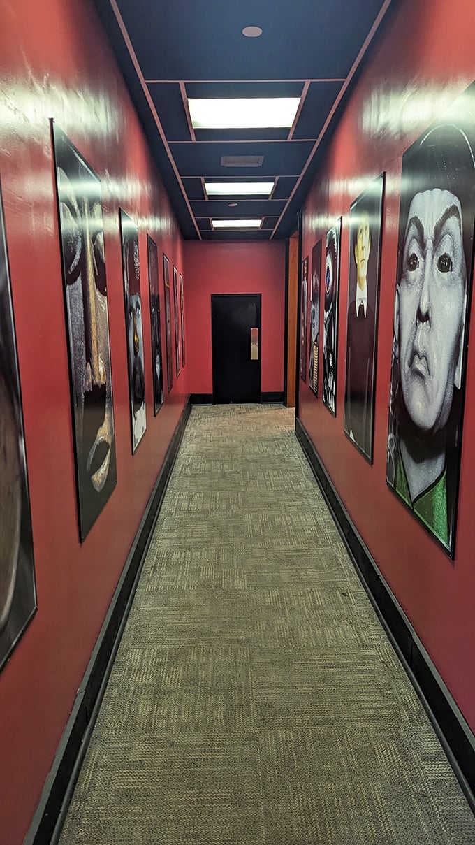 This crimson corridor feels like walking through a gallery curated by Vincent Price. Those eyes follow you everywhere.